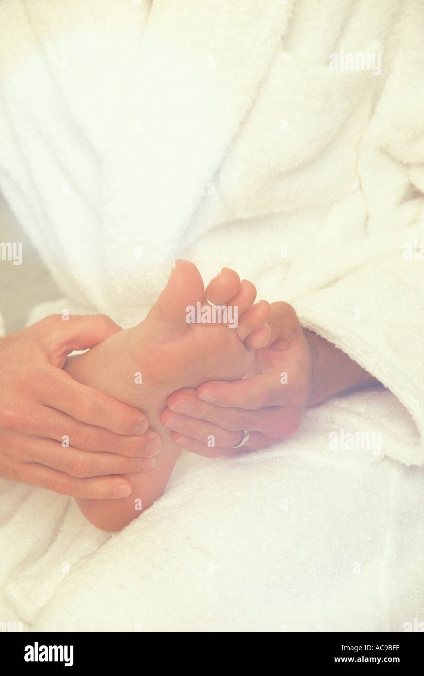 Mans hand massages woman s foot Stock Photo - Alamy