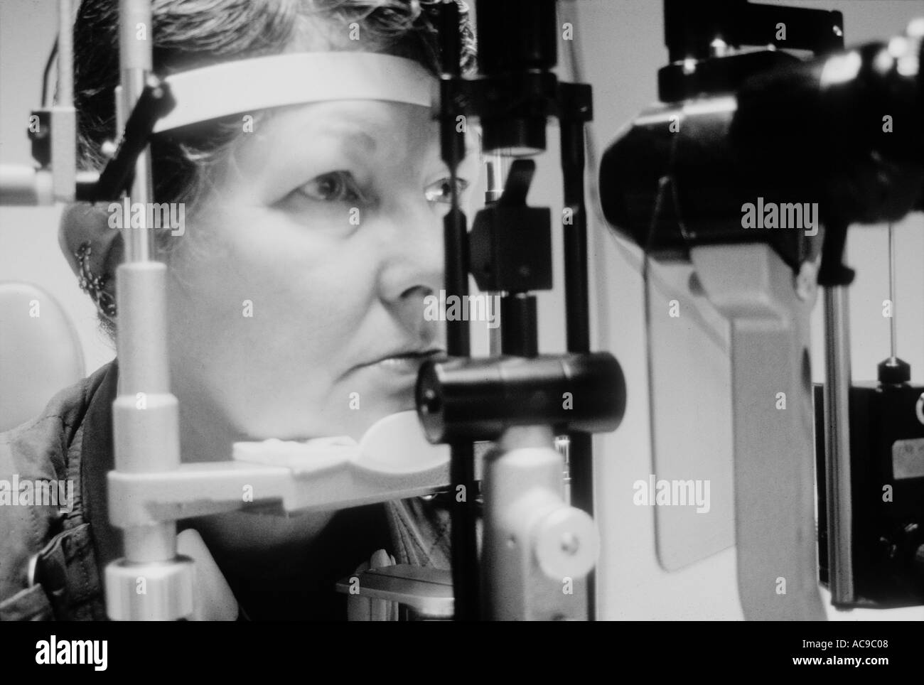 A woman at an optometrists office having her eyes examined Stock Photo ...