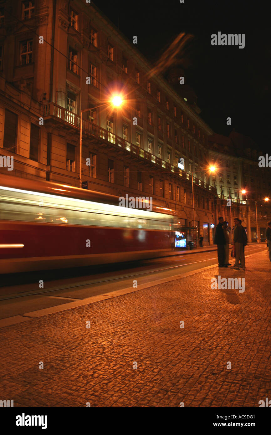 A streak of light: Tram speeds through a nocturnal Prague street Stock ...