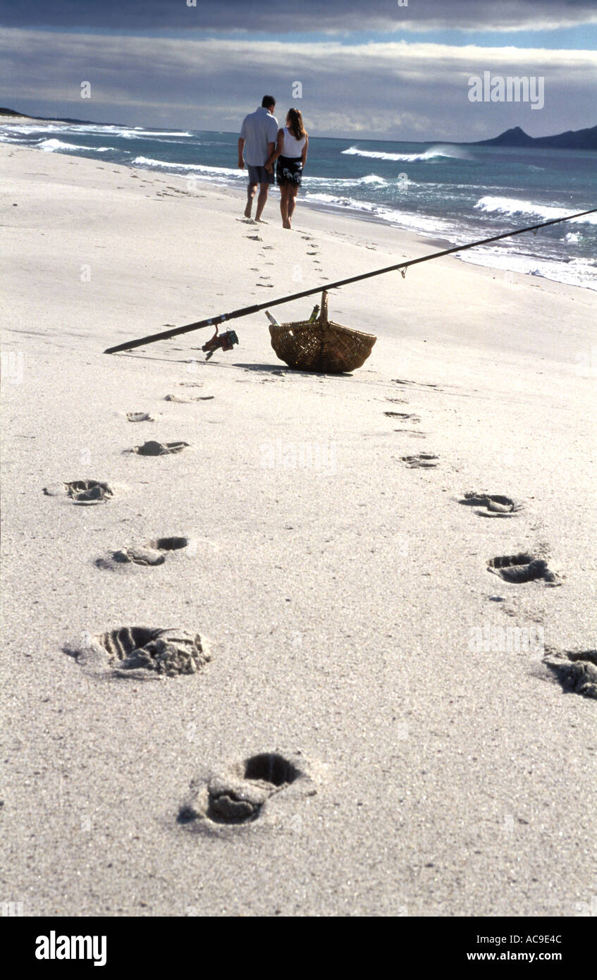 A couple fishing and walking on the beach, Tasmania, australia. photo ...