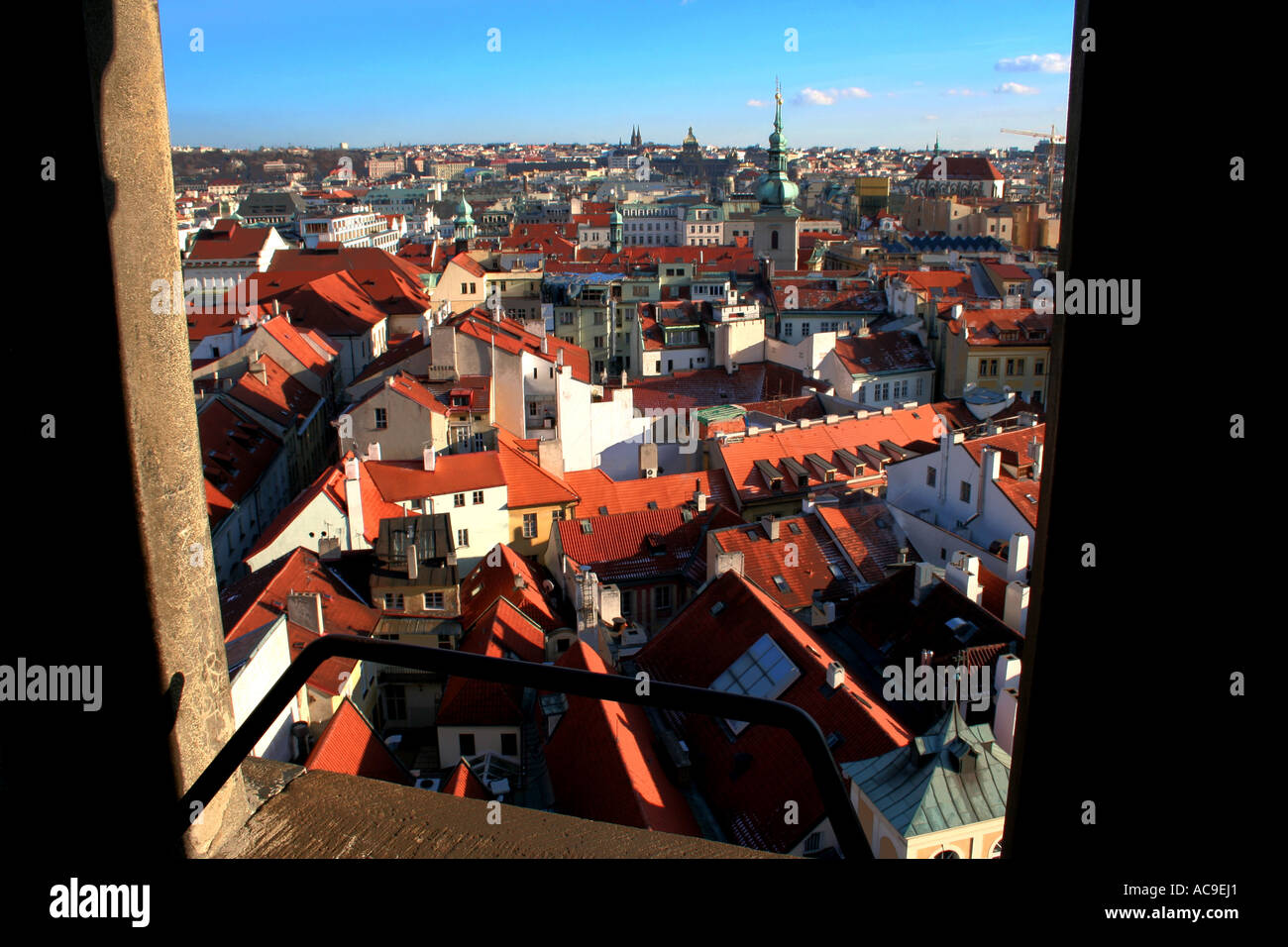 A sweeping aerial view of Prague's historic rooftops, punctuated by the ...