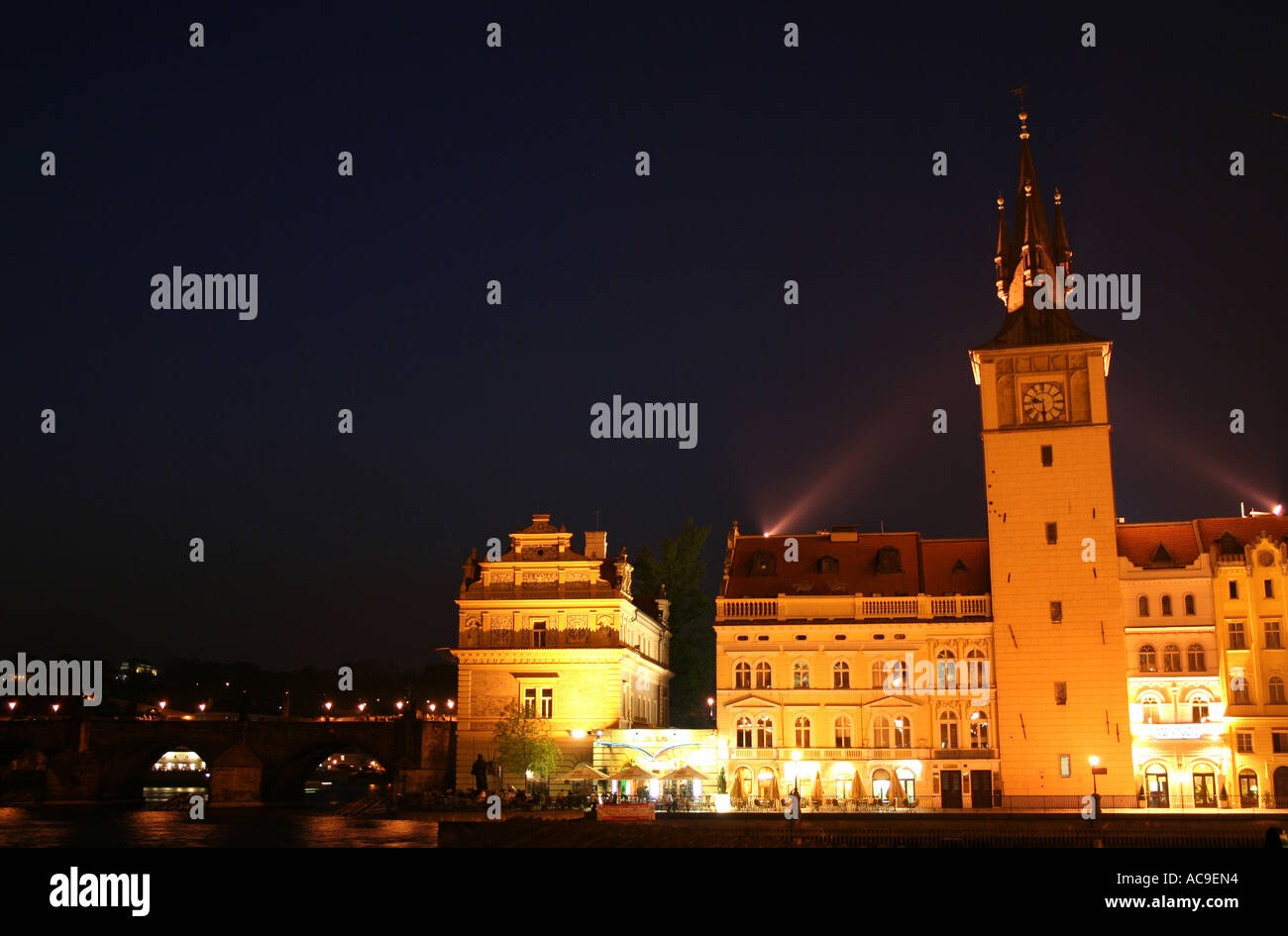 Staromestska water tower and nearby buildings illuminated at night near ...