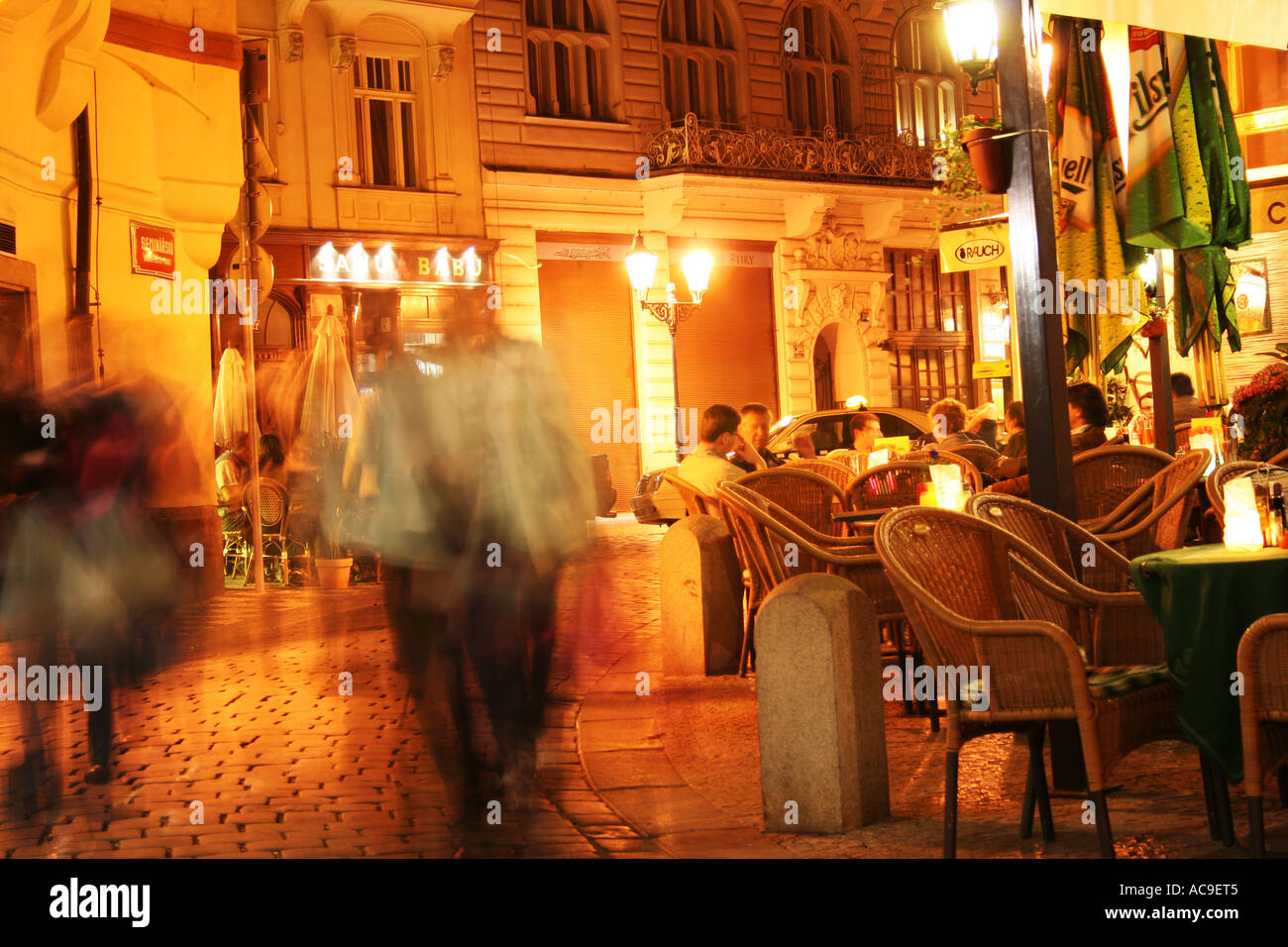 Outdoor restaurant scene in Prague at night with people dining under ...