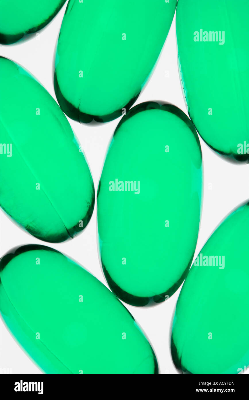 Close up of green capsule pills against white background Stock Photo ...