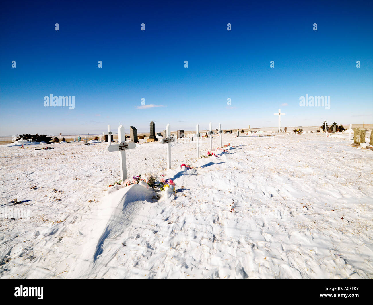 Snow covered graveyard with clear blue sky in background Stock Photo ...
