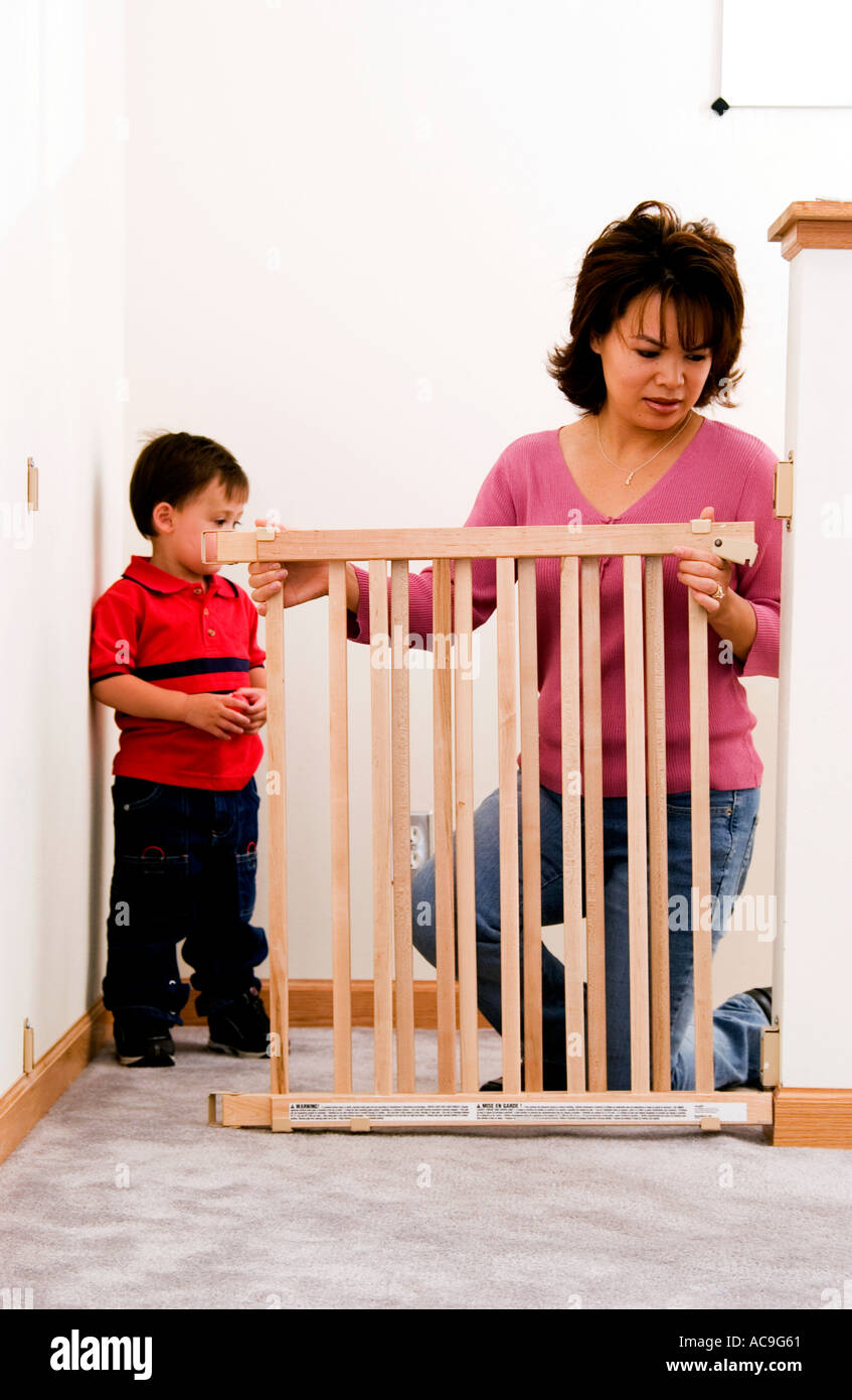 Mother and son putting up gate Stock Photo - Alamy
