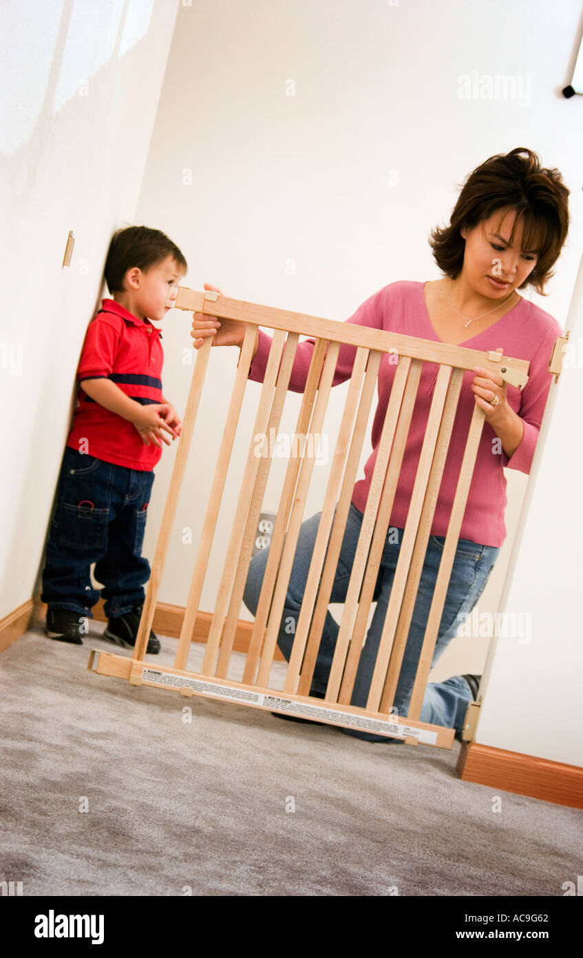 Mother and son putting up gate Stock Photo - Alamy