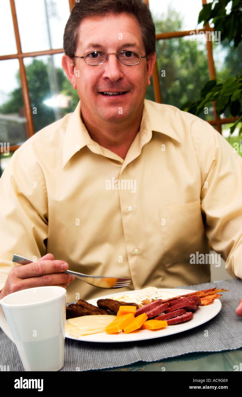 Man eating breakfast Stock Photo - Alamy