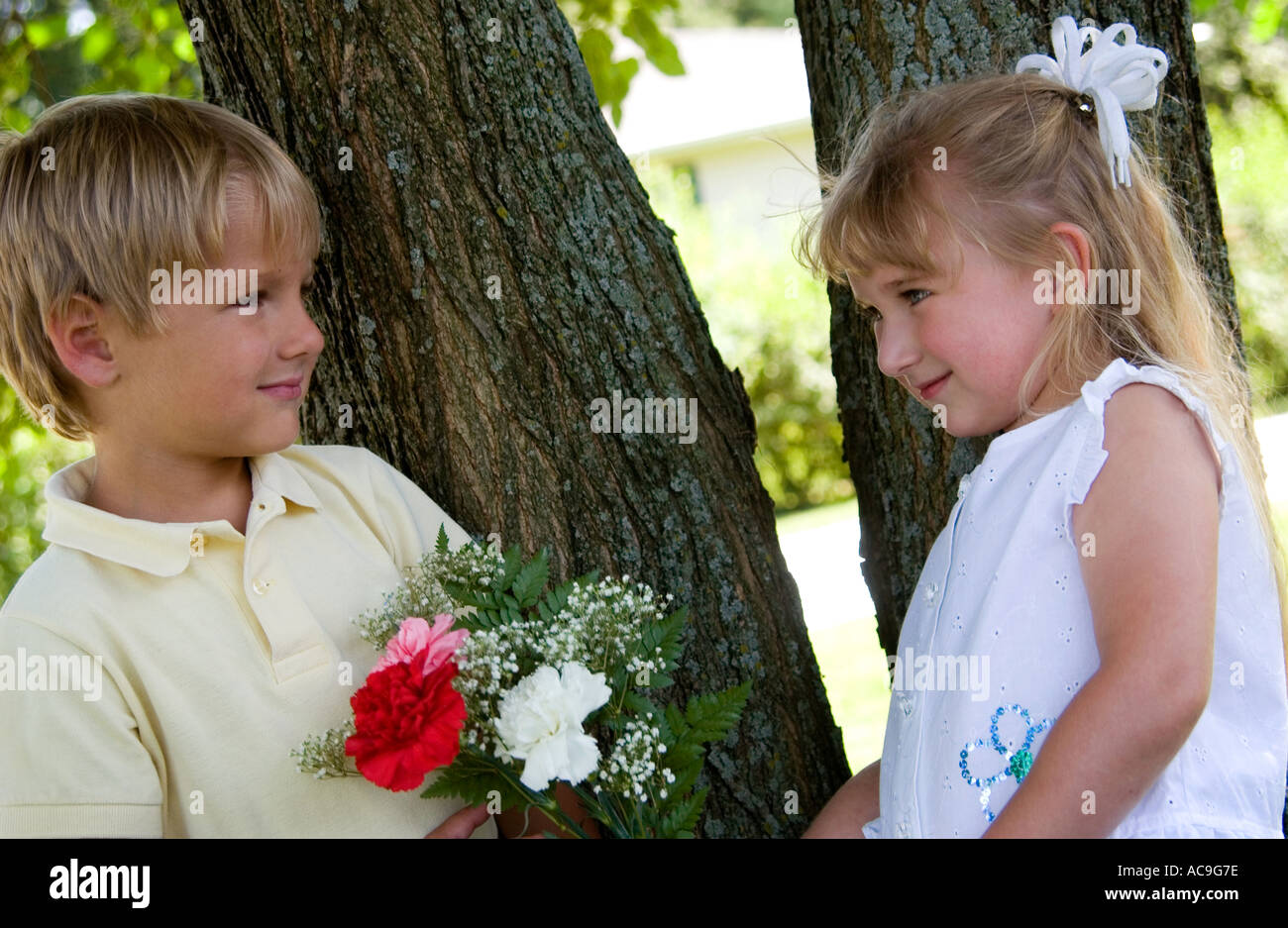 Boy giving girl flowers Stock Photo - Alamy