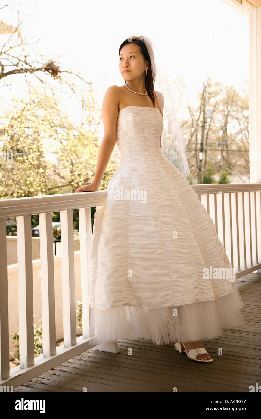 Portrait of an Asian bride leaning against railing Stock Photo - Alamy