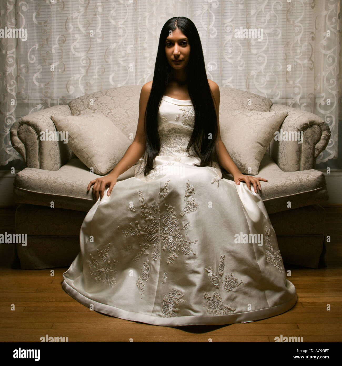 Portrait of an Indian bride sitting on a love seat Stock Photo - Alamy