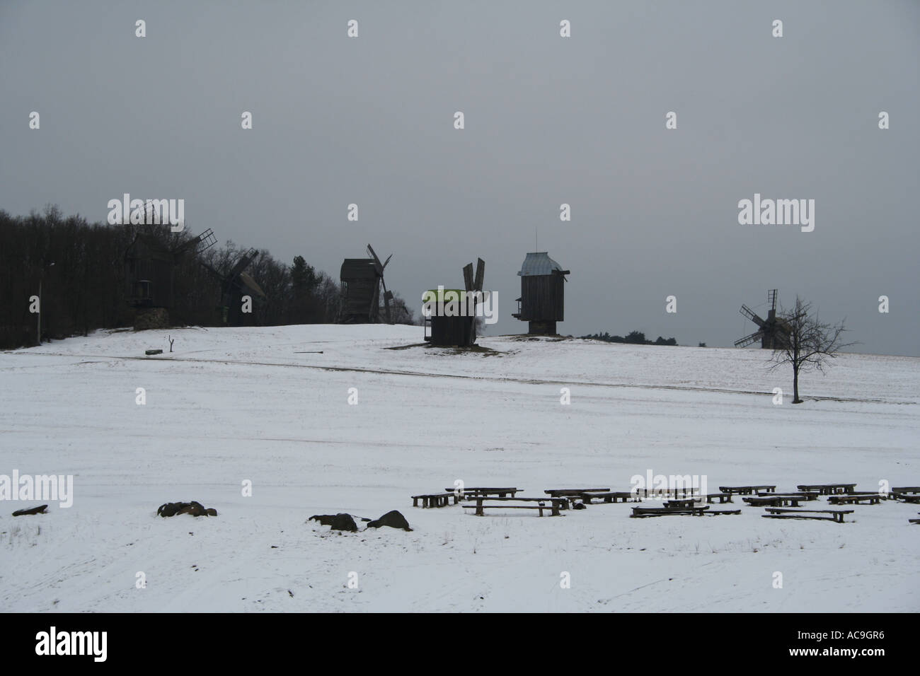 Traditional windmills on a snowy hill in Ukraine, showcasing the ...
