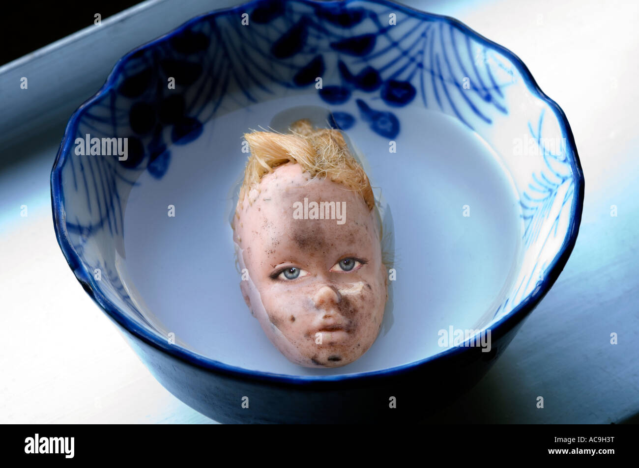 Doll Head Floating in Bowl Stock Photo - Alamy