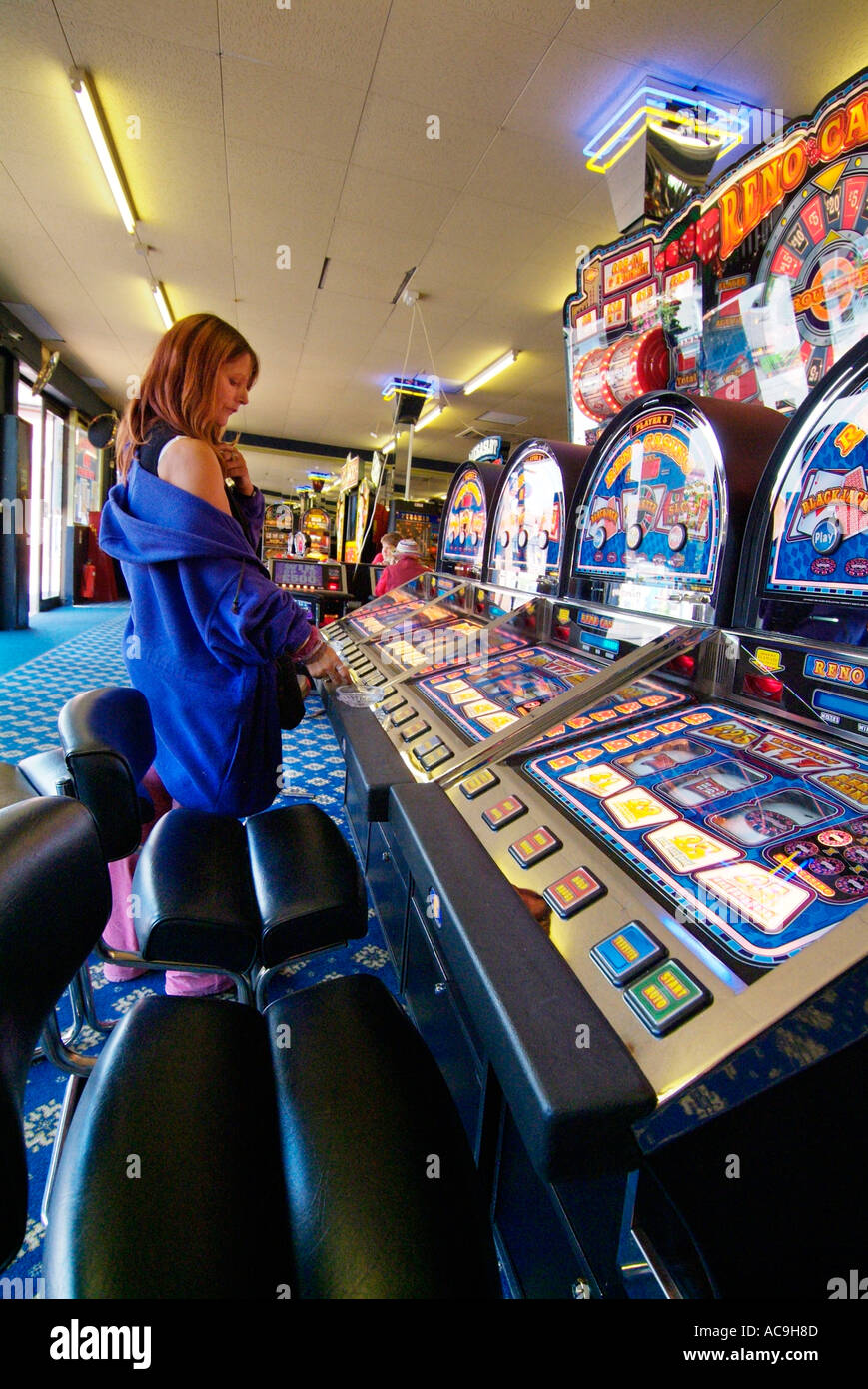 Amusement arcade sea side one arm bandit slot machine gamble woman ...