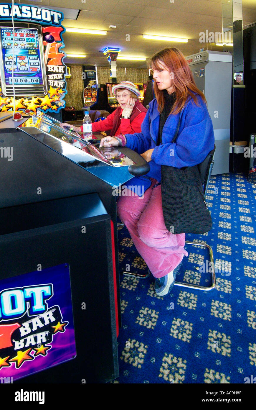 Amusement arcade sea side one arm bandit slot machine gamble woman ...
