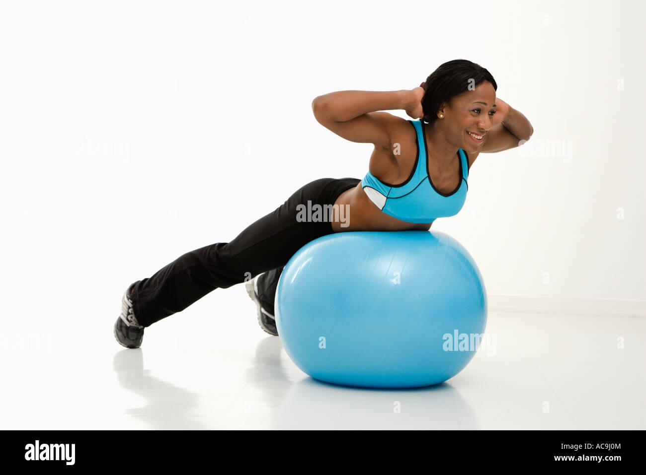 African American young adult woman working out with exercise ball Stock ...