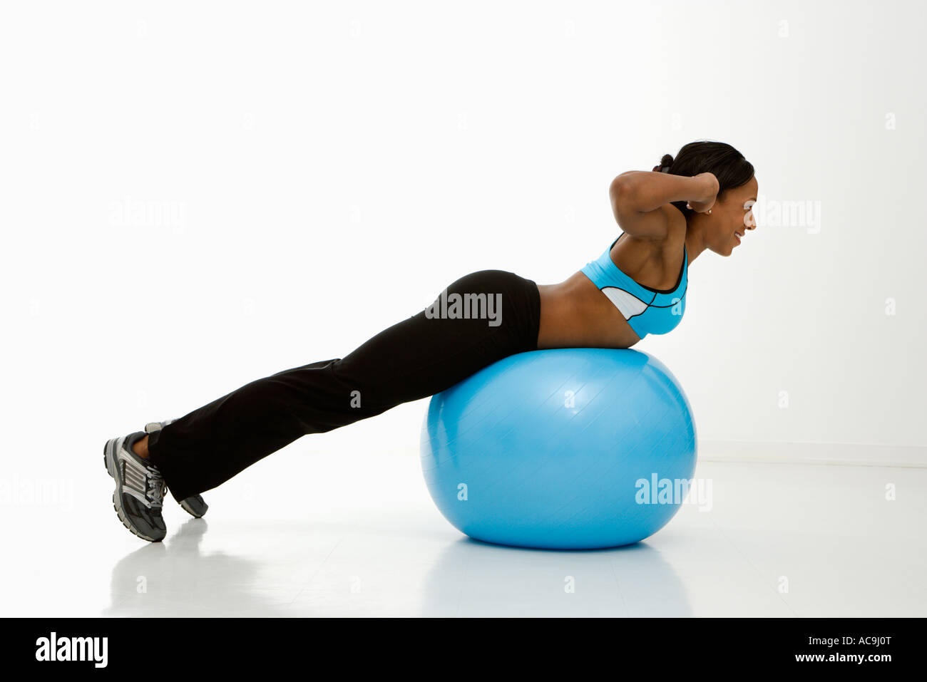 Profile of African American young adult woman working out with exercise ...
