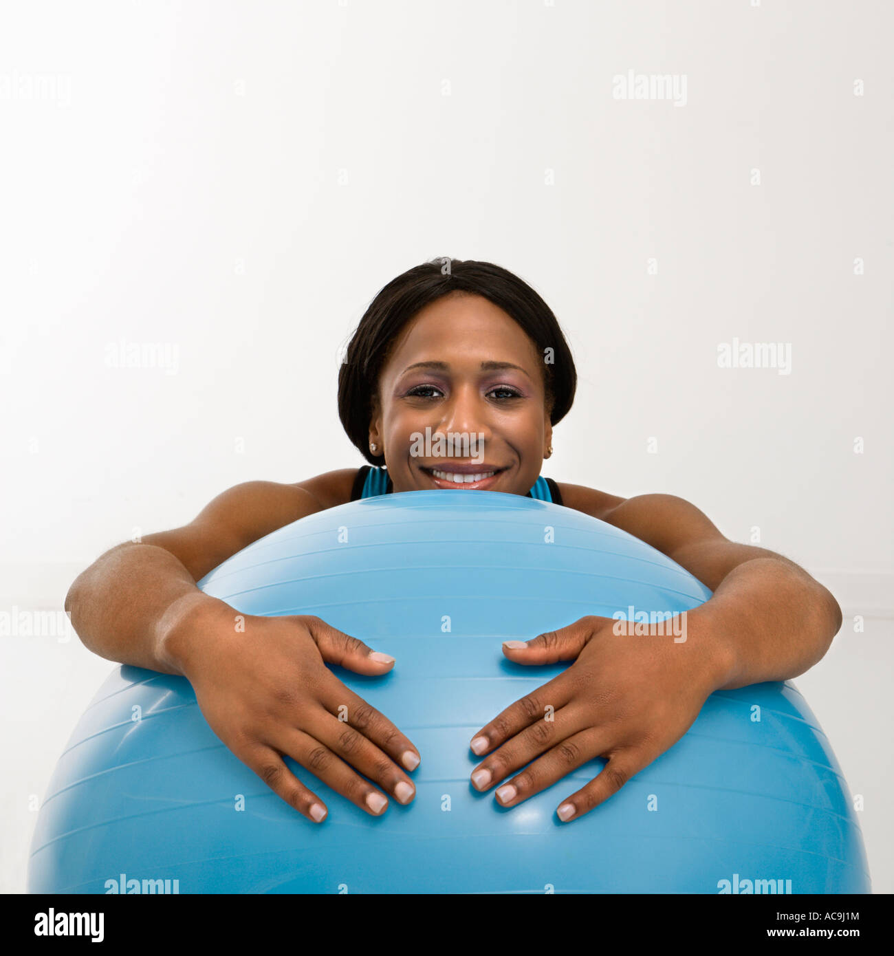 African American young adult woman resting with arms draped over ...