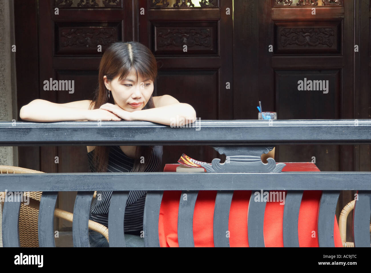 Woman Leaning On Railing At Traditional Chinese Teahouse Stock Photo ...