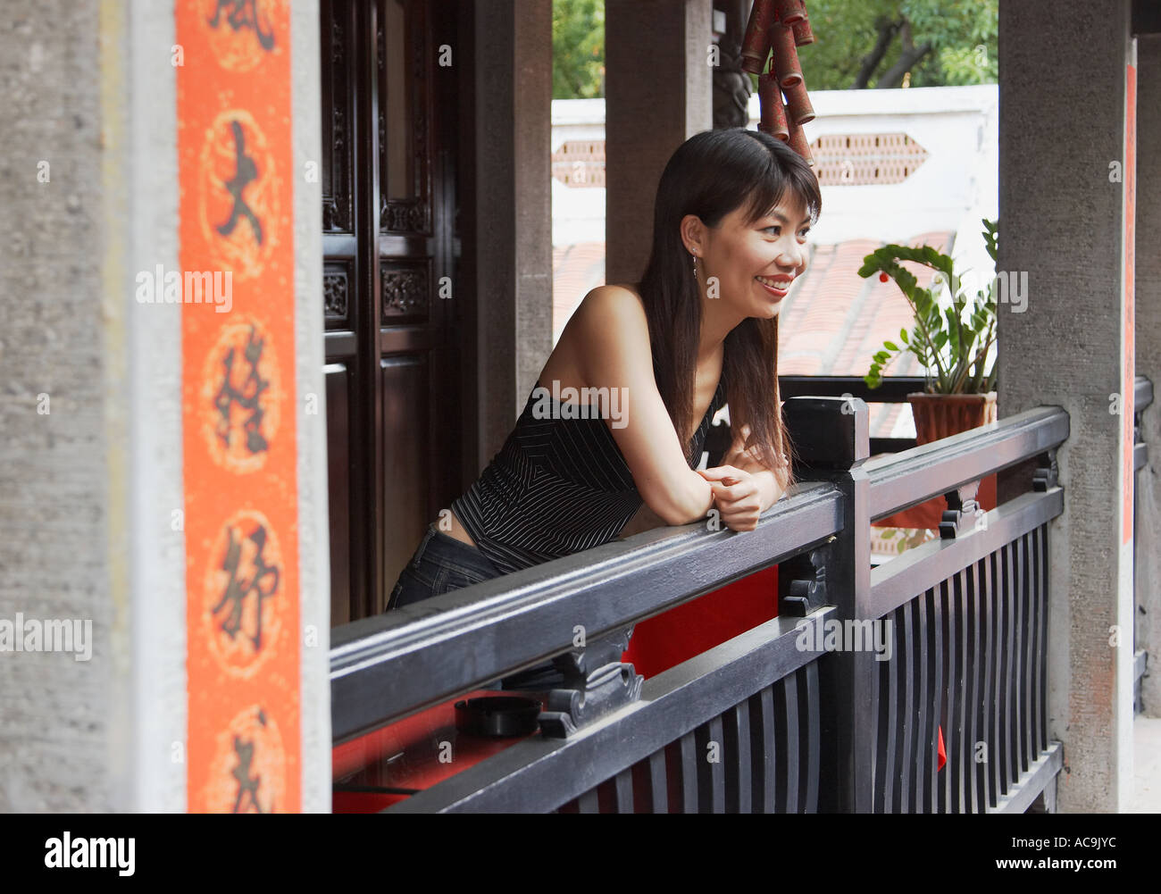 Woman Leaning On Railing At Traditional Chinese Teahouse Stock Photo ...