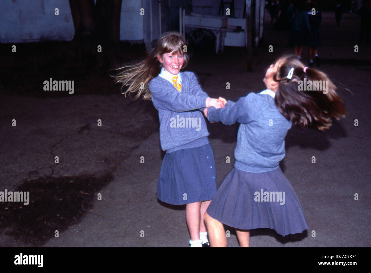 Two school girls spinning Stock Photo - Alamy
