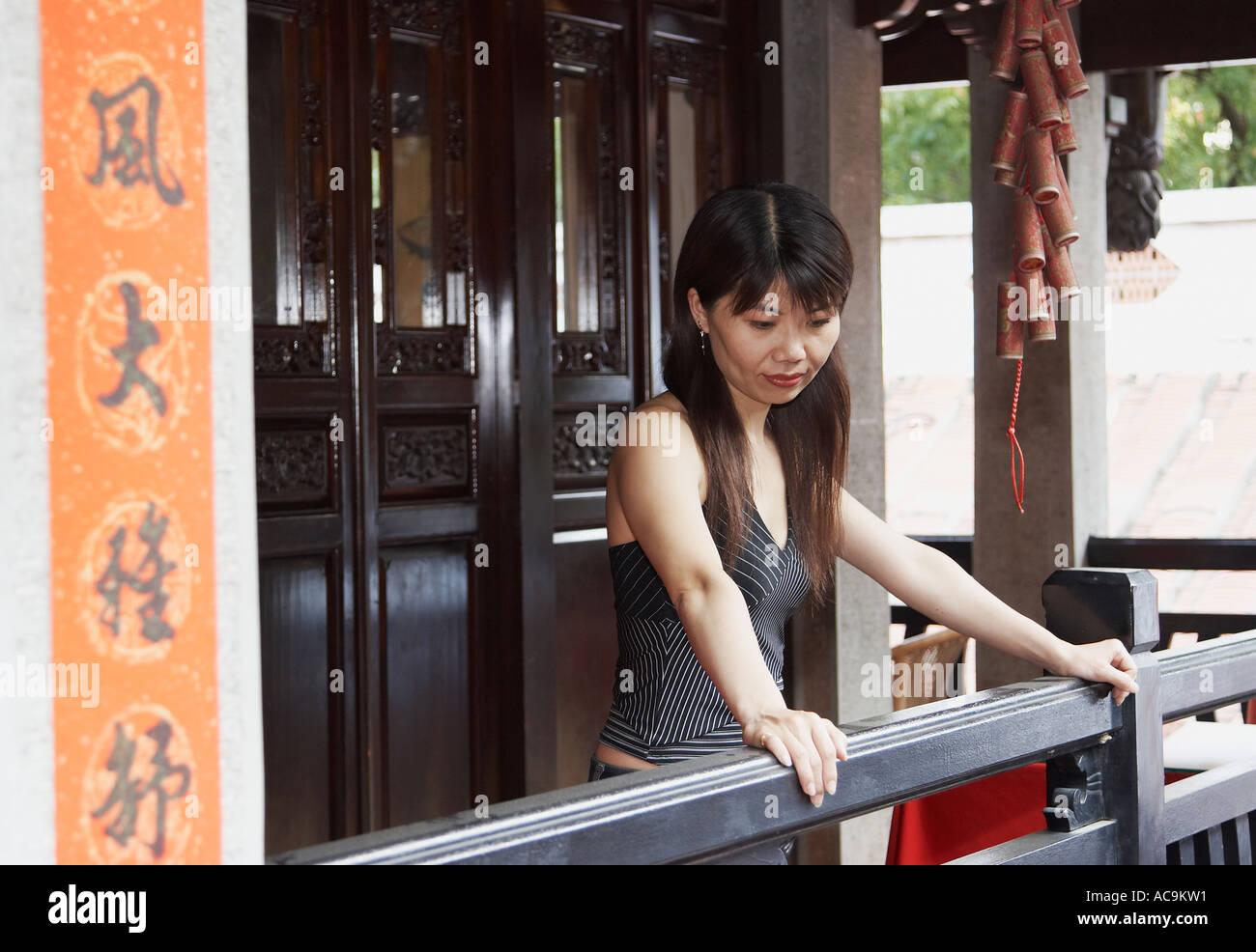 Woman Leaning On Railing At Traditional Chinese Teahouse Stock Photo ...