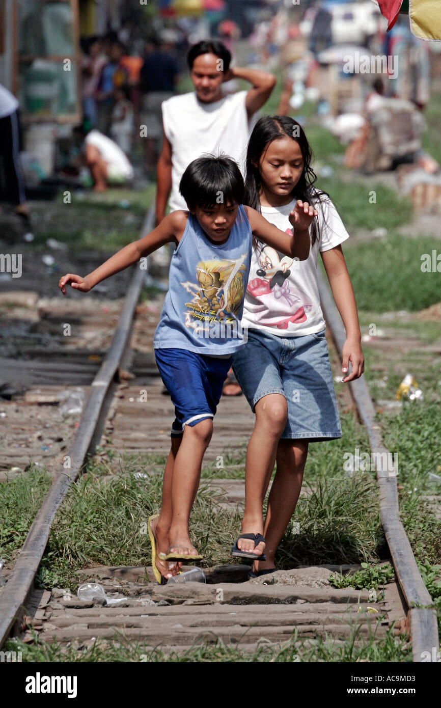 Kids playing on the railway lines Manila Stock Photo - Alamy