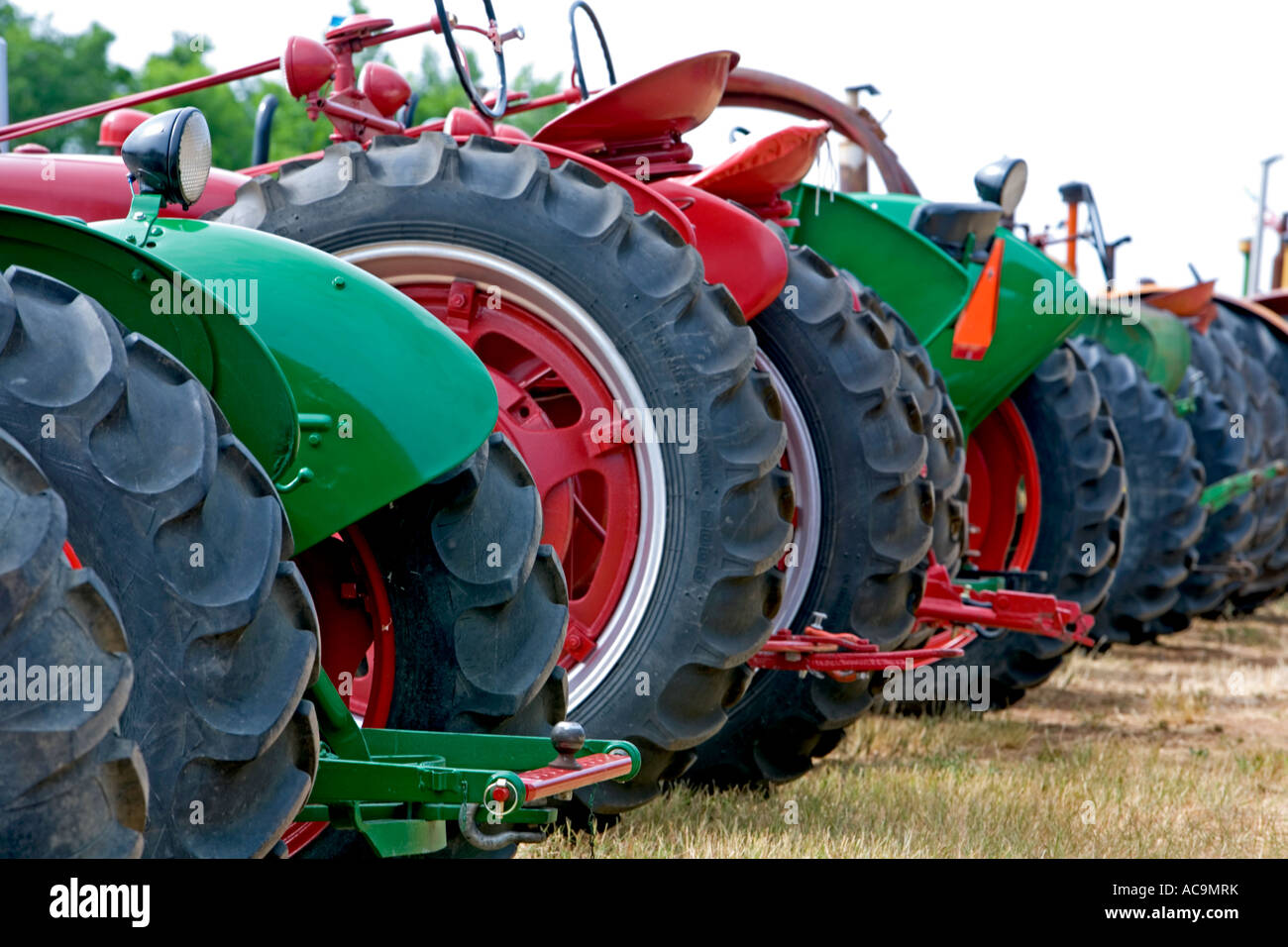Tractor rear wheels view lined up a city celebration Stock Photo - Alamy