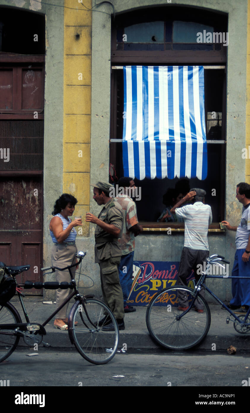 Cuban army soldier in khaki uniform with other locals queuing outside ...