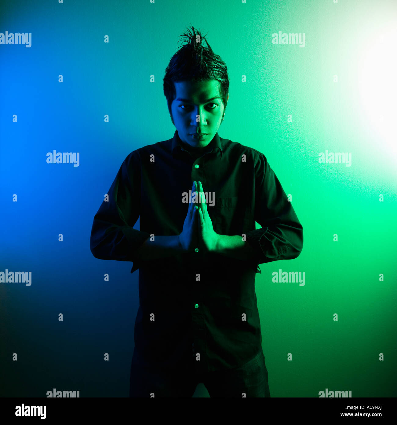 Portrait of attractive young Asian Filipino man standing holding hands ...