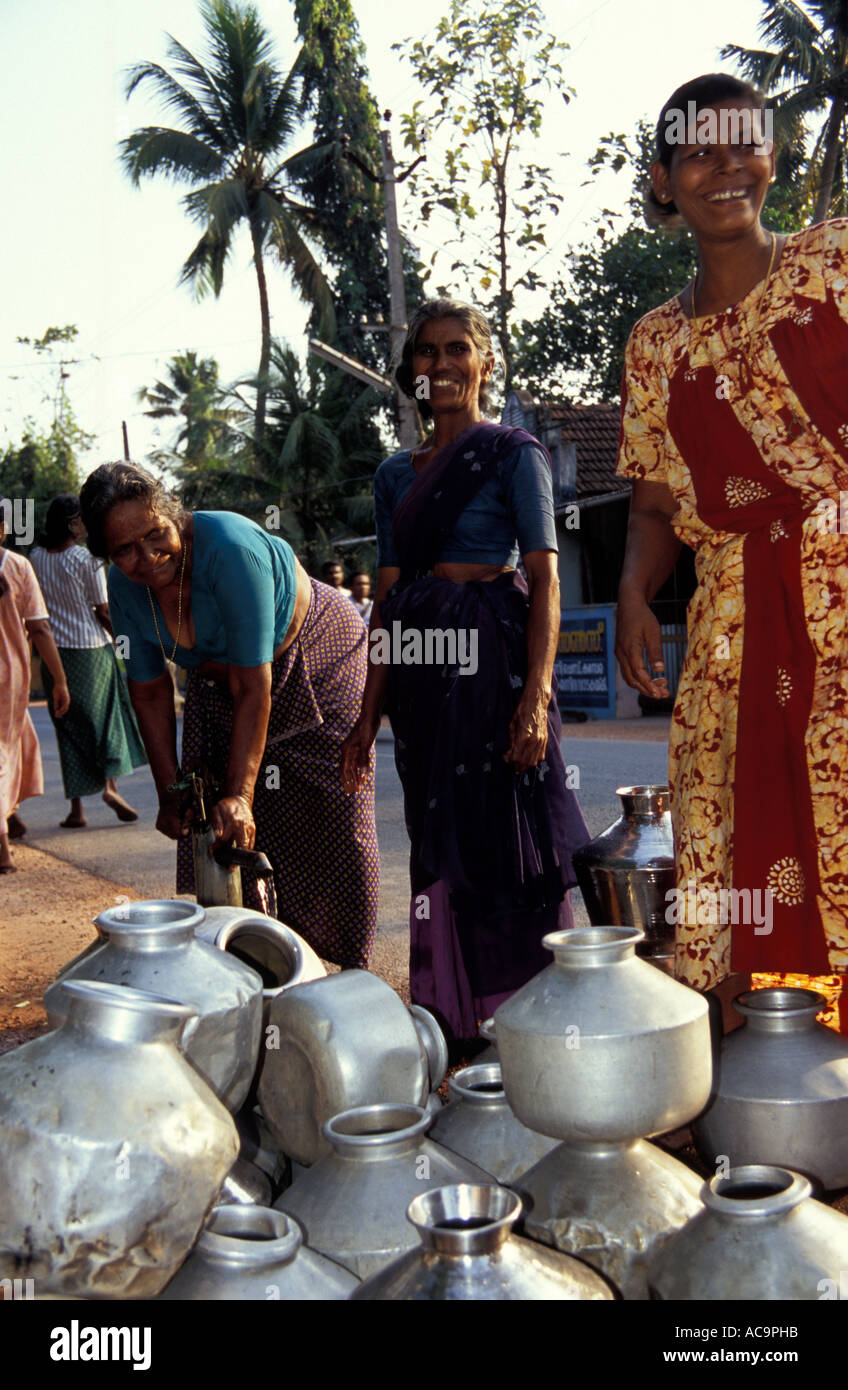 Indian women filling canisters from water tap, Vypeen Island, Kochi ...