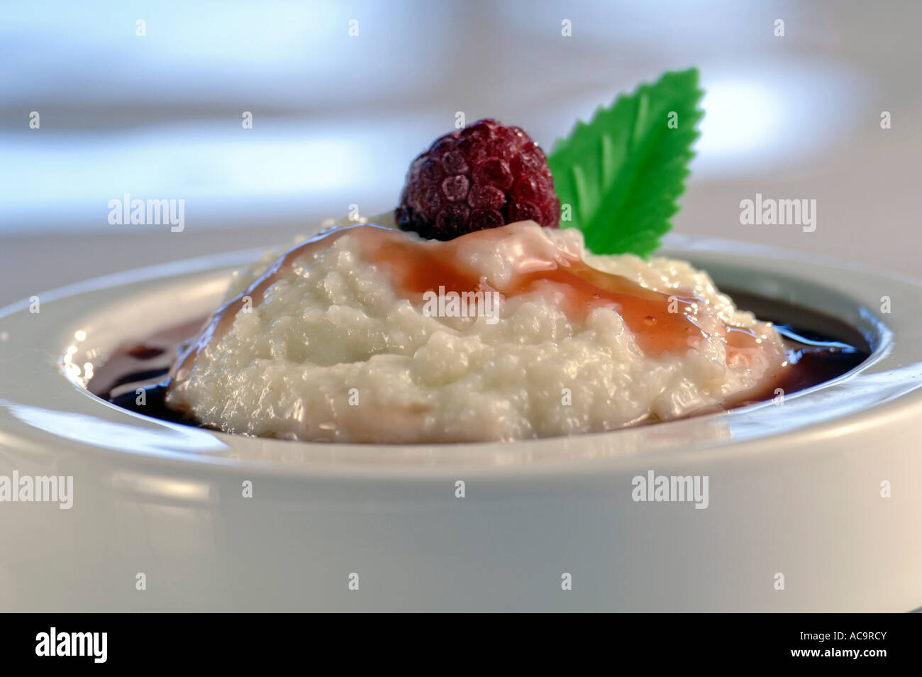 Rice pudding with raspberry sauce Stock Photo - Alamy