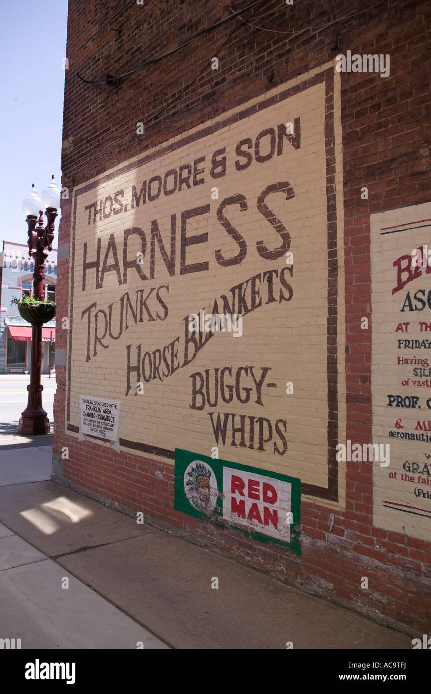 Old signs advertising local goods have been repainted to look new ...
