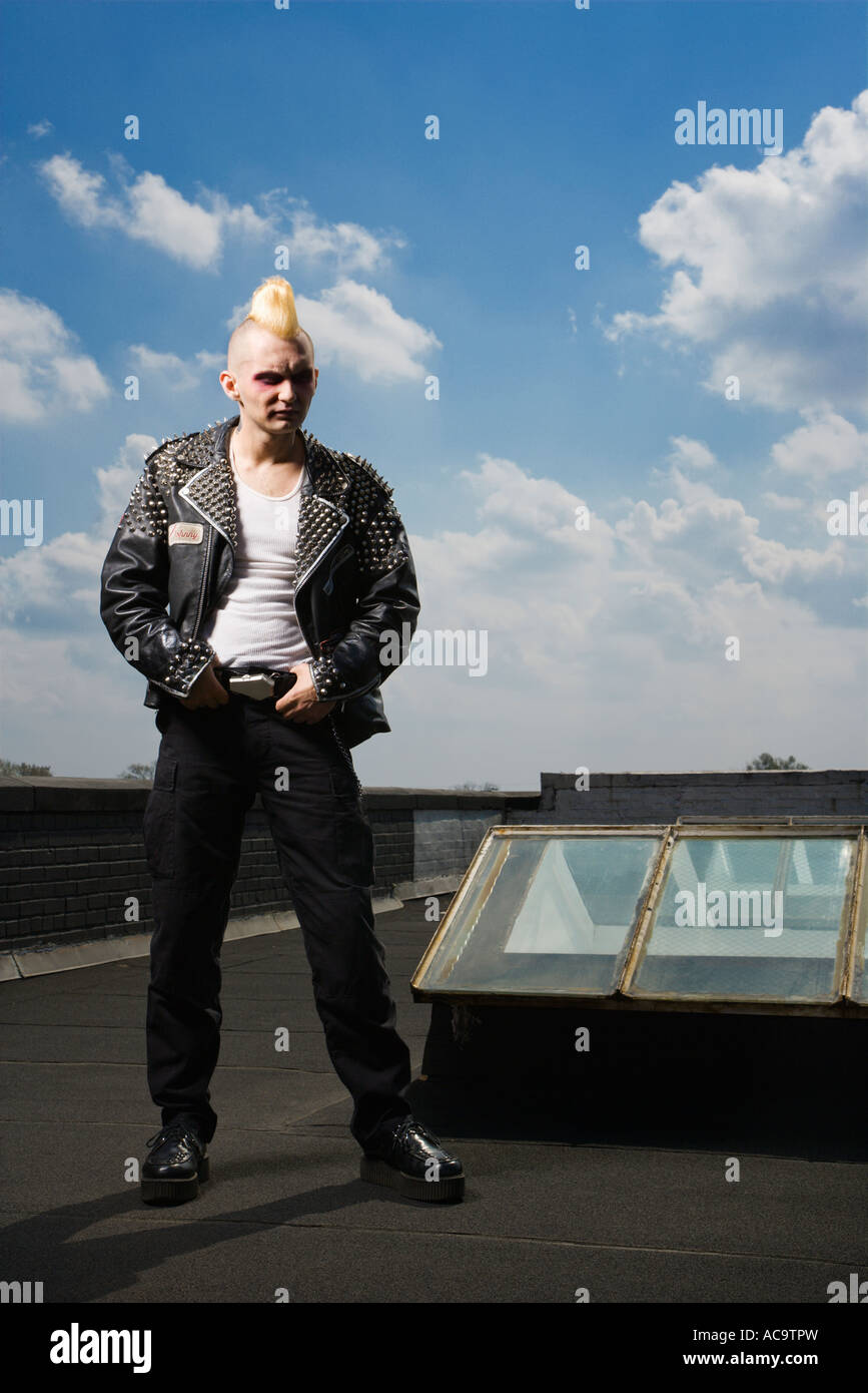 Portrait of mid adult Caucasian male punk standing on roof Stock Photo ...