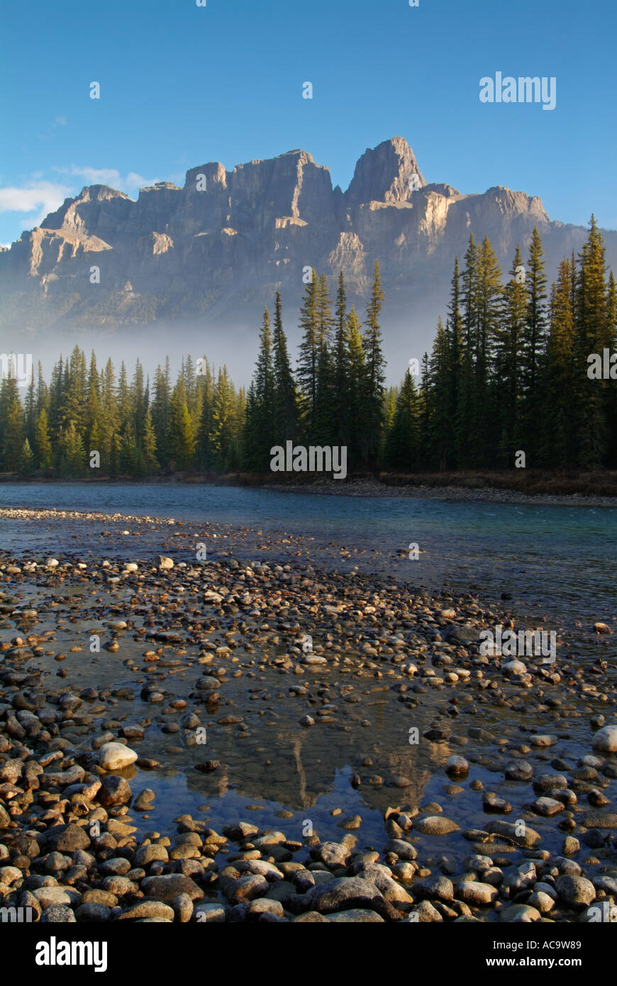Mist rising from Bow river Castle Mountain early morning at castle Junction Bow Valley Parkway ...