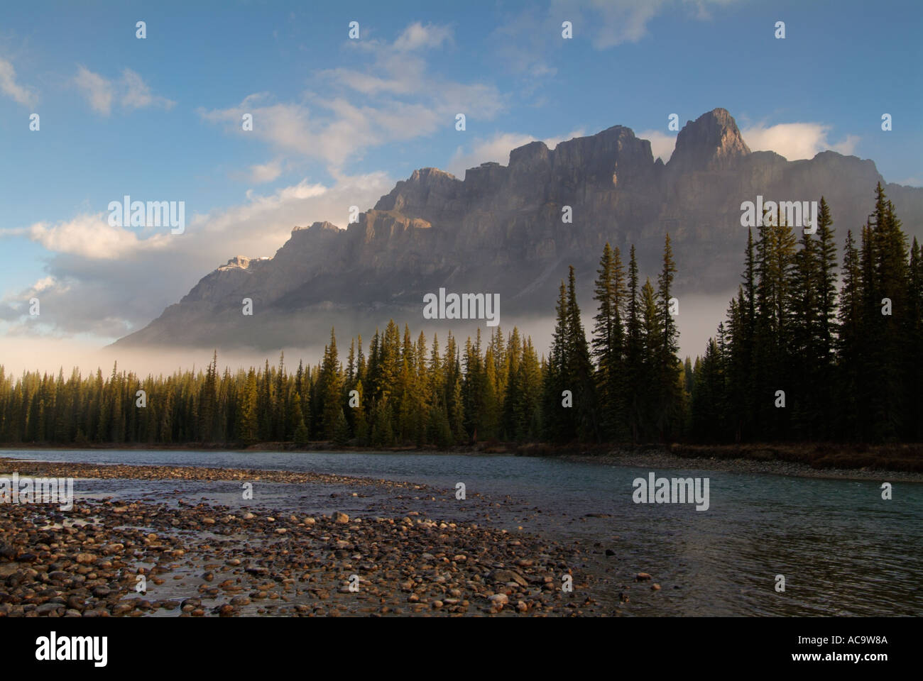 Mist rising from Bow river Castle Mountain early morning at castle Junction Bow Valley Parkway ...