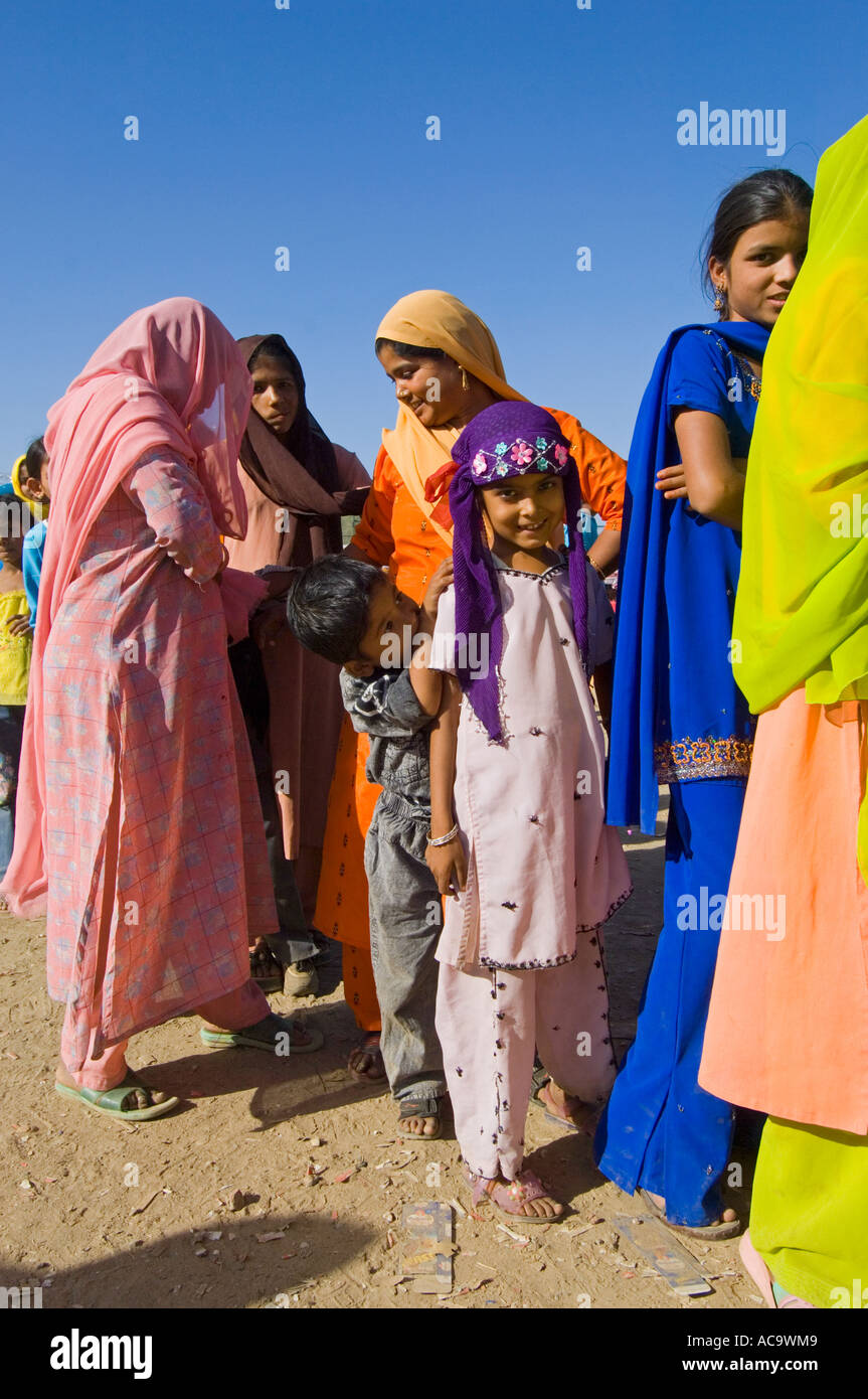 A long queue of women and girls dressed in their finest clothes waiting ...