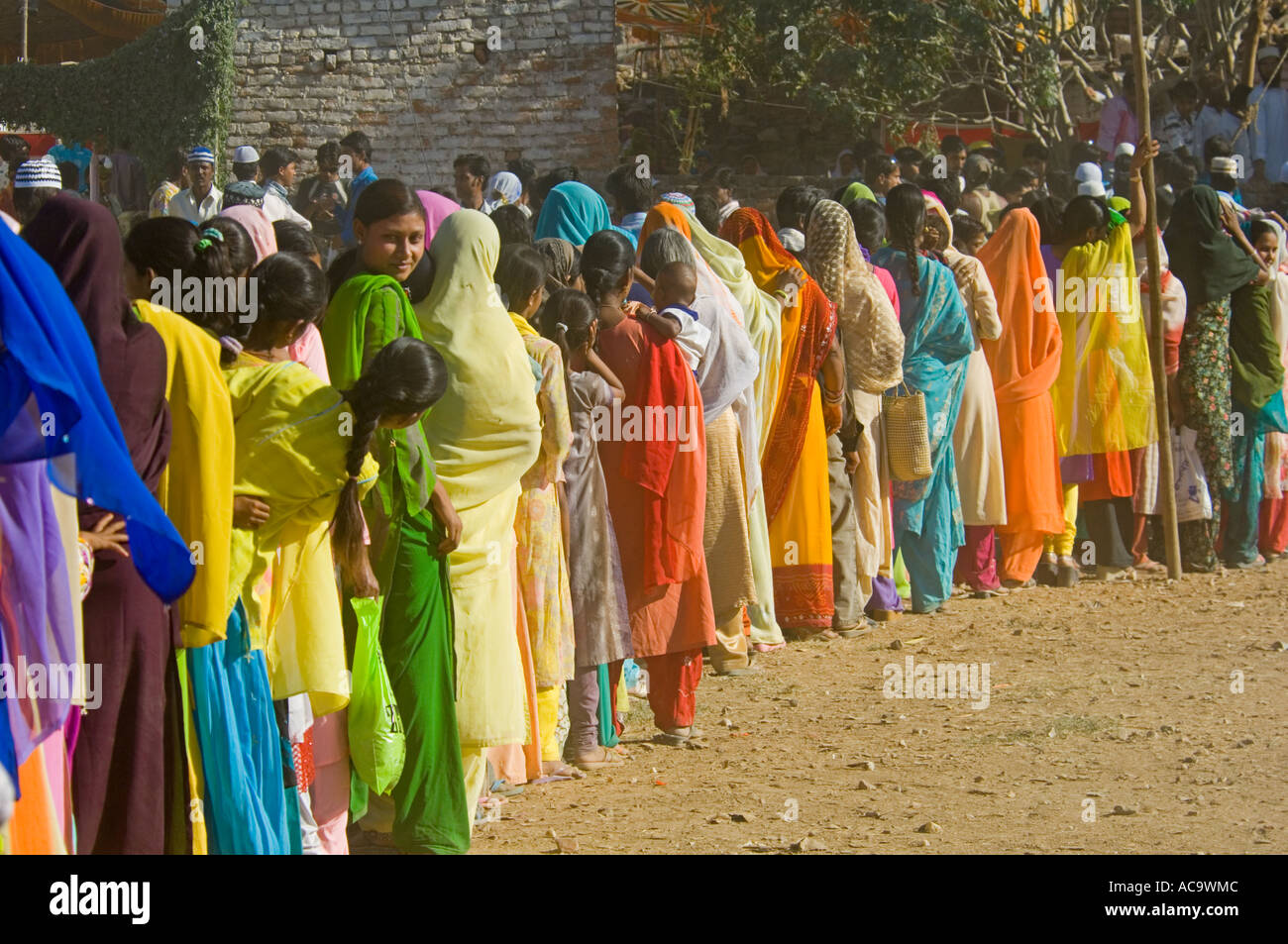 A long queue of women and girls dressed in their finest clothes waiting ...
