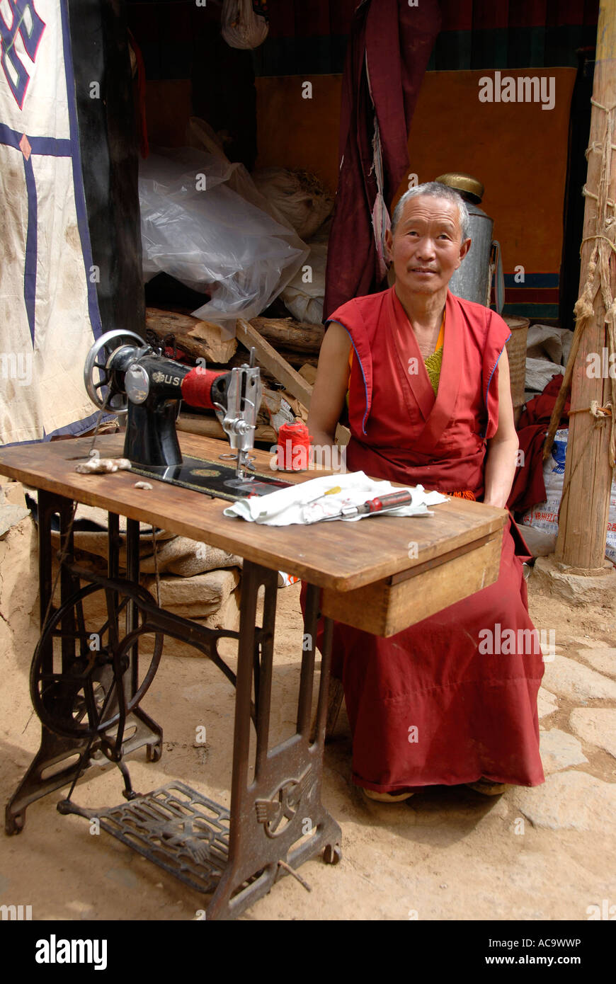 Buddhist monk working with an old Singer sewing machine Reting ...