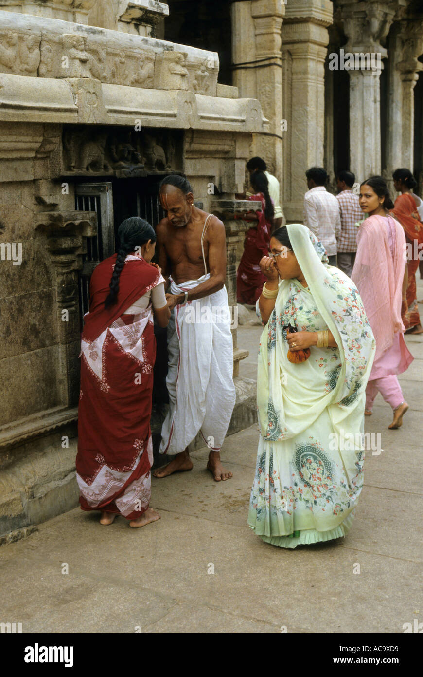 Women greeting a Hindu priest outside the famous Sri Ranganathaswamy ...