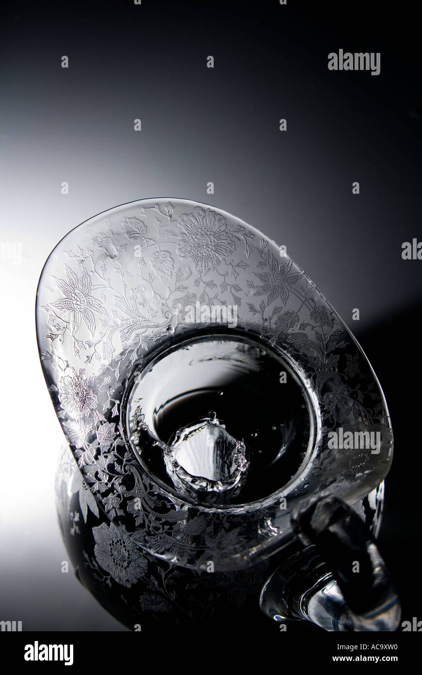 Action shot of water droplet splashing into crystal pitcher Stock Photo ...