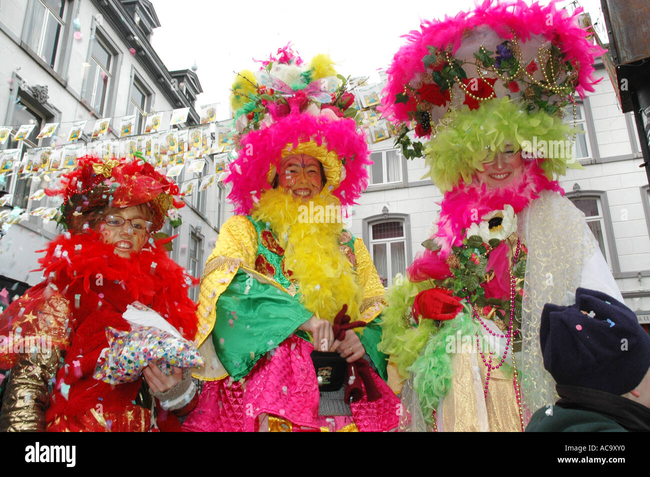Three colourful ladies dressed in carnival colours red yellow green ...