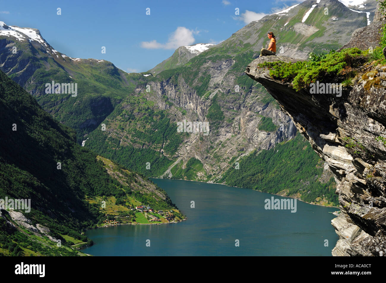 Woman sitting on a ledge, Geiranger Fjord, Hellesylt, More og Romsdal ...