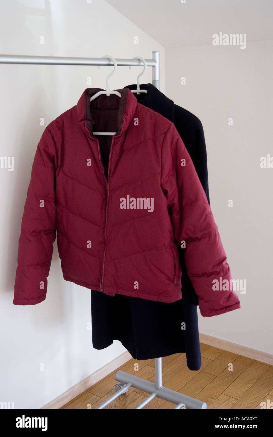 Jackets hanging on coat hanger Stock Photo - Alamy