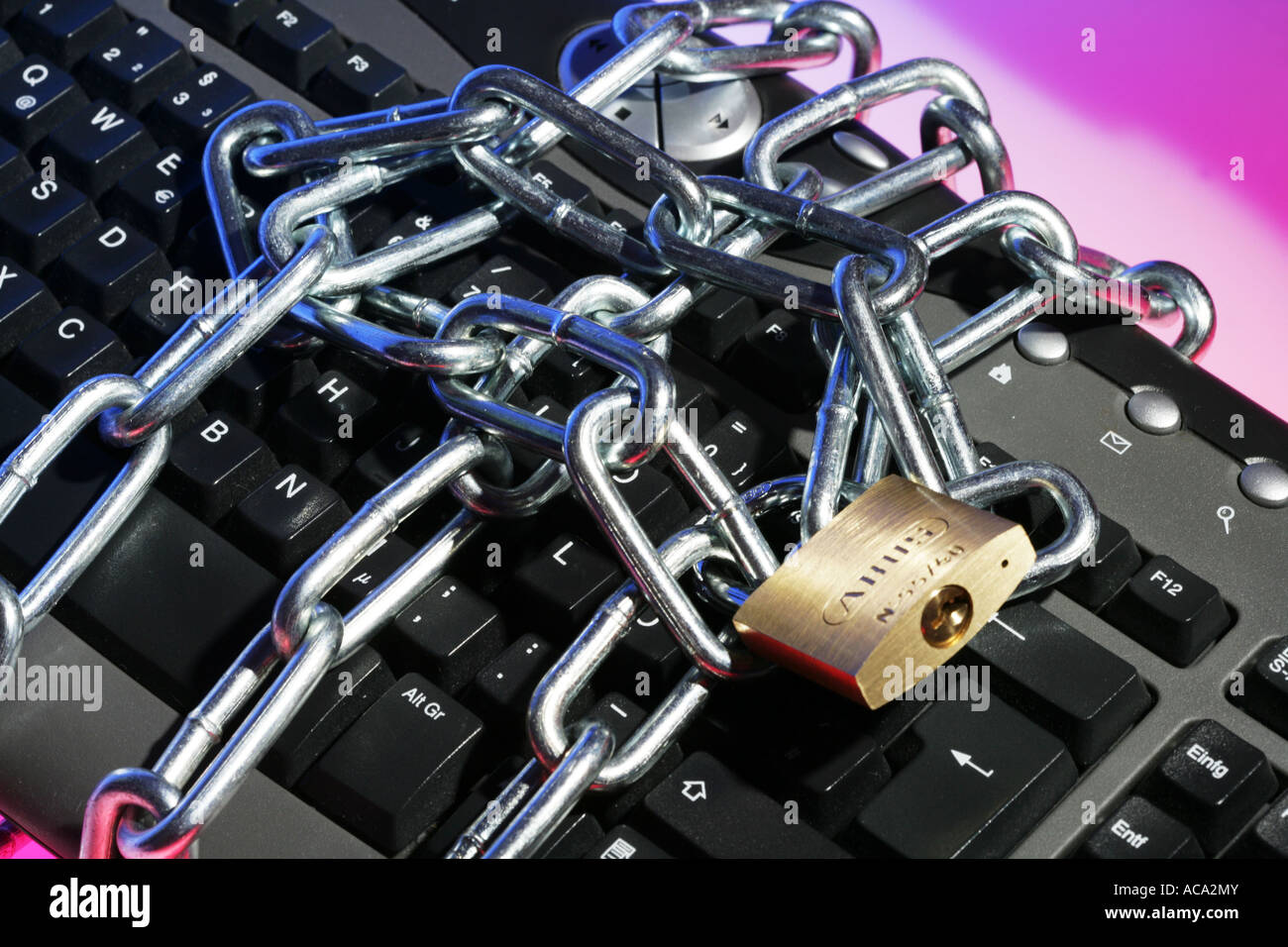 Symbolic photo, computer safety, keyboard in chains with lock Stock ...