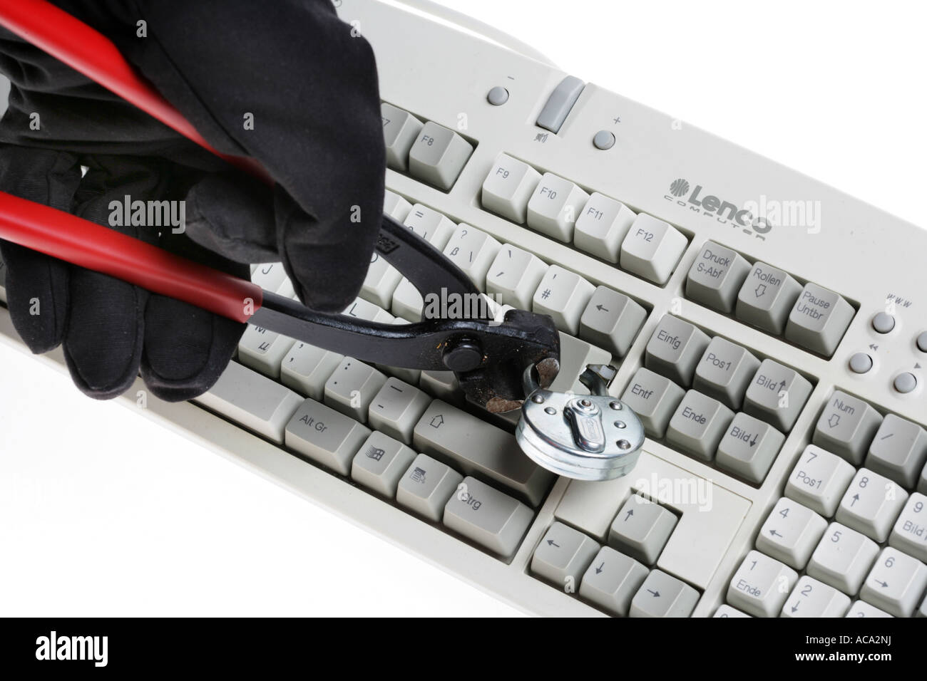 Symbolic photo, computer security. Computer keyboard with lock, tongs ...