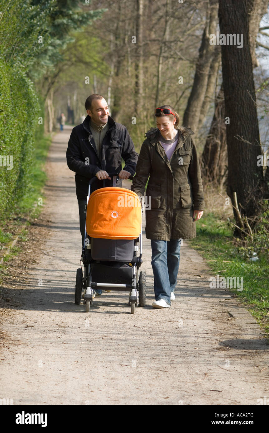 Young family with pram taking a walk Stock Photo - Alamy