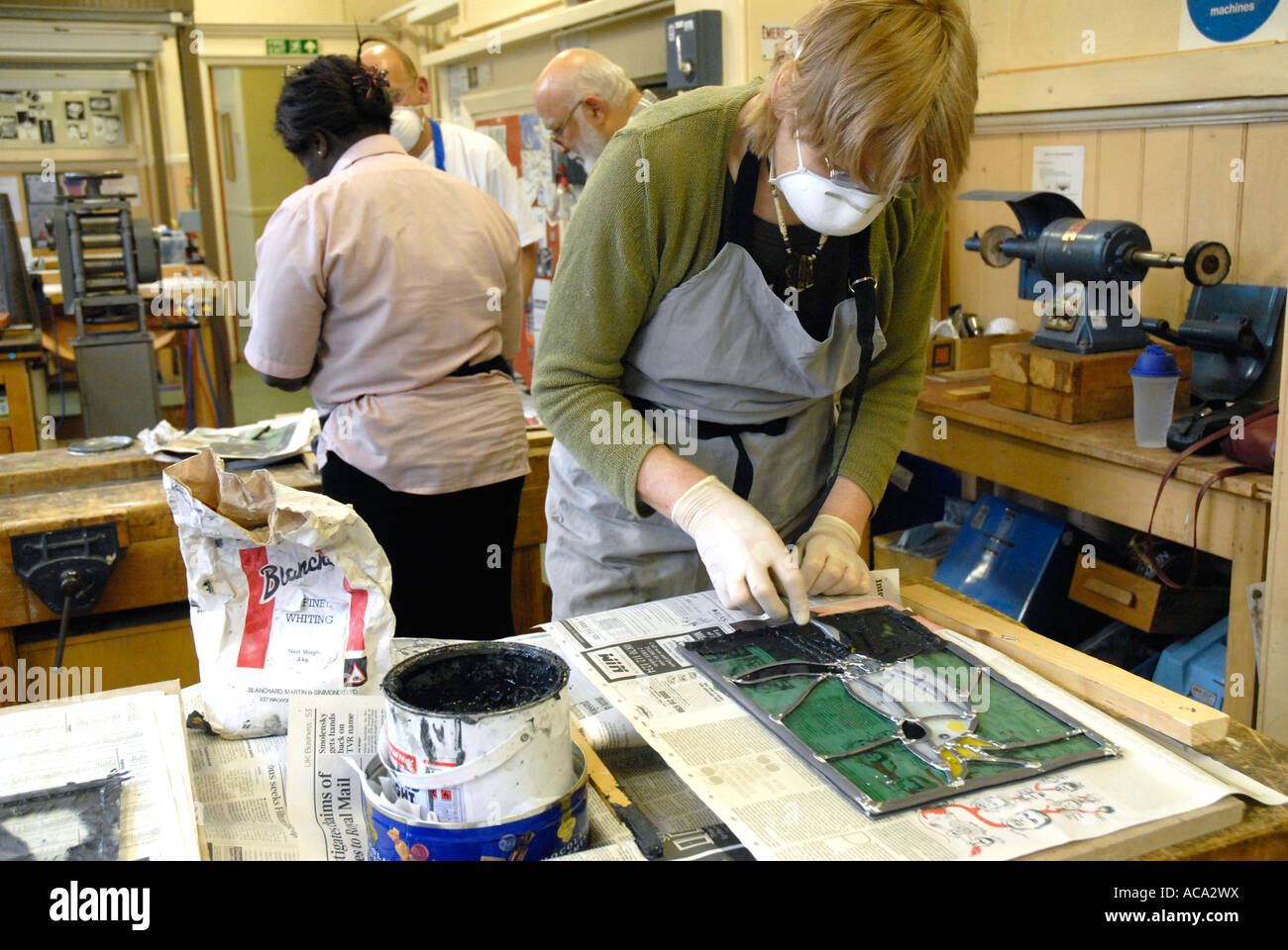 Woman working on stained Glass panel in adult learning class. Model ...