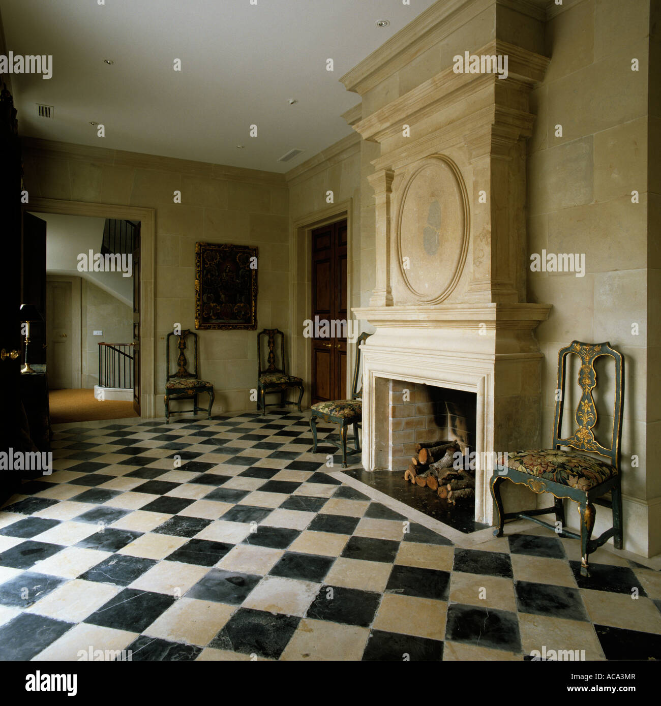 Stone fireplace in empty reception room with chequered floor Stock ...