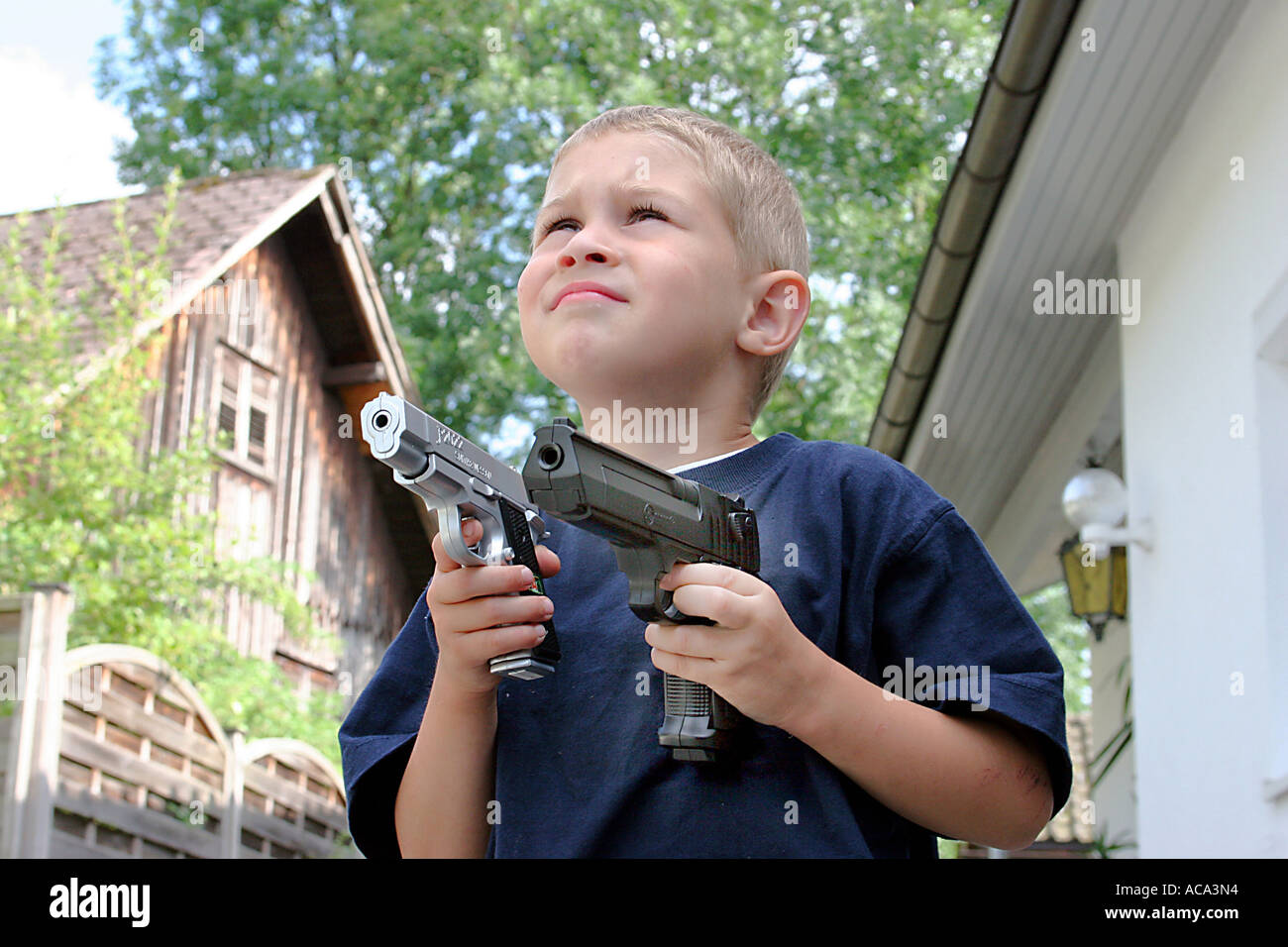 Child with a toys pistol Stock Photo - Alamy